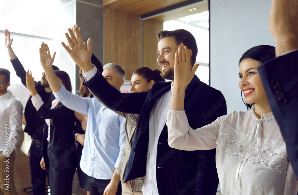 Happy audience asking questions after presentation. Group of people ...
