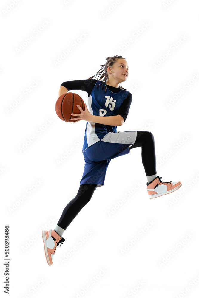 Throwing ball in a jump. Portrait of teen girl in blue uniform training ...