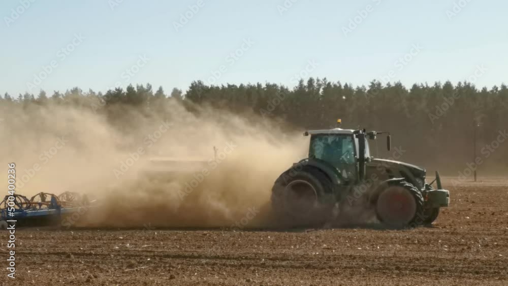 Side view agricultural tractor prepares duty soil affected by drought ...