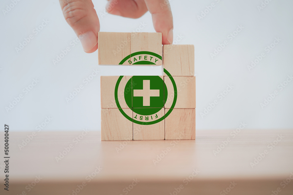 senior's hand completed green safety first sign on wooden cube blocks ...