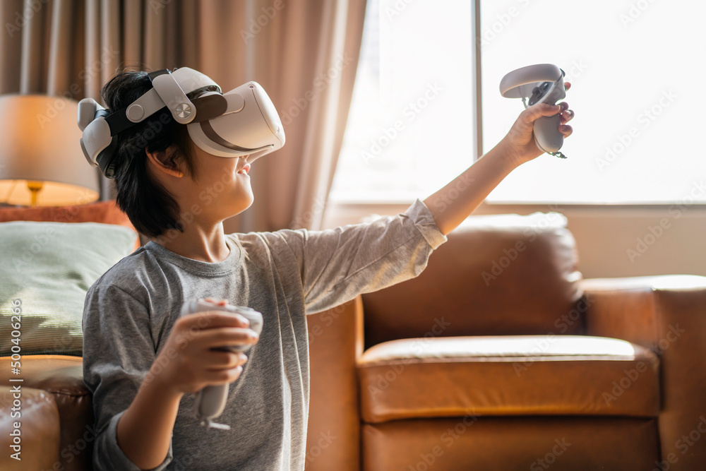 exiting asian child male boy enjoy metaverse gaming with wearable vr ...