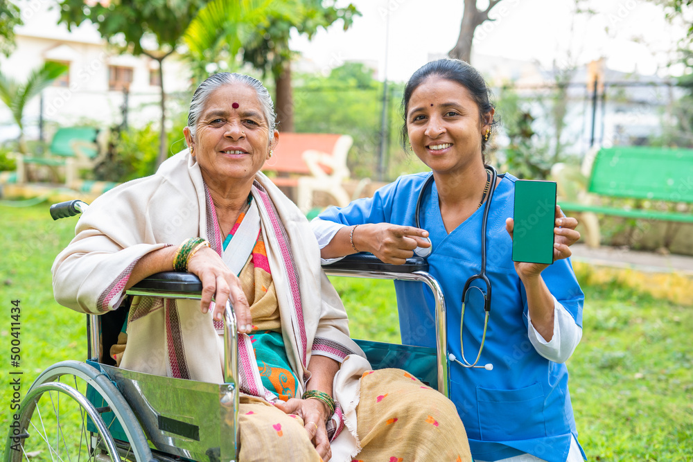 doctor showing green screen mobile phone wile patient sitting on ...