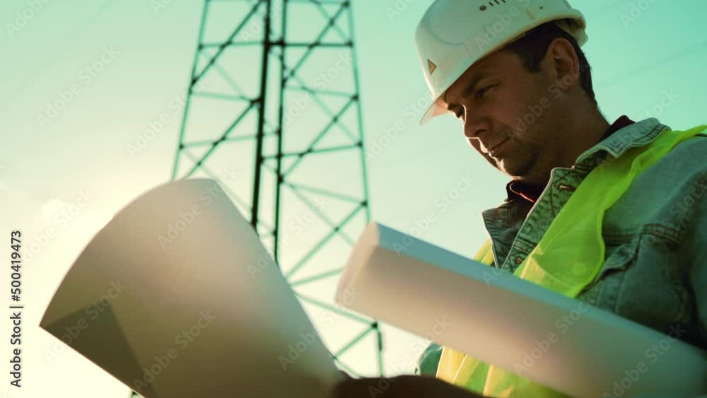Worker male engineer using documents for checking data while standing ...