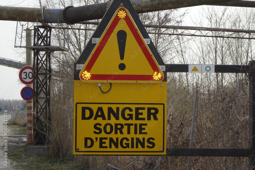 Yellow, red and black French traffic warning sign 'Danger! Exit of ...