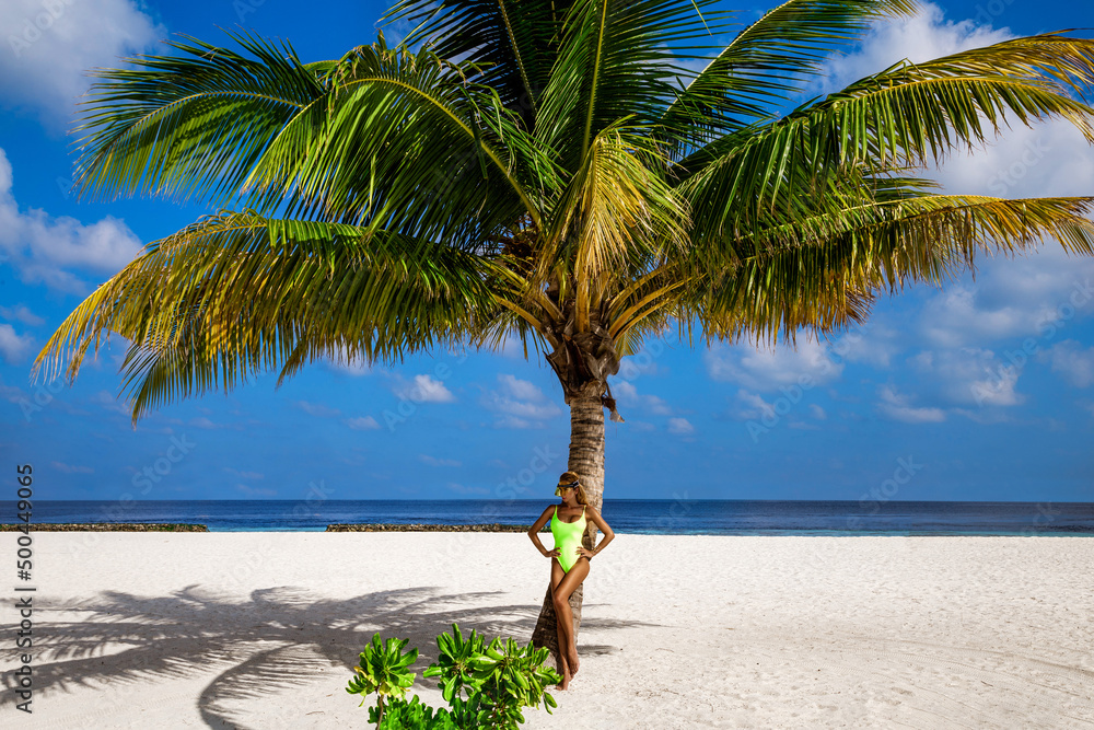 Beautiful sexy tanned woman in bikini on Maldives island. Young glamour ...