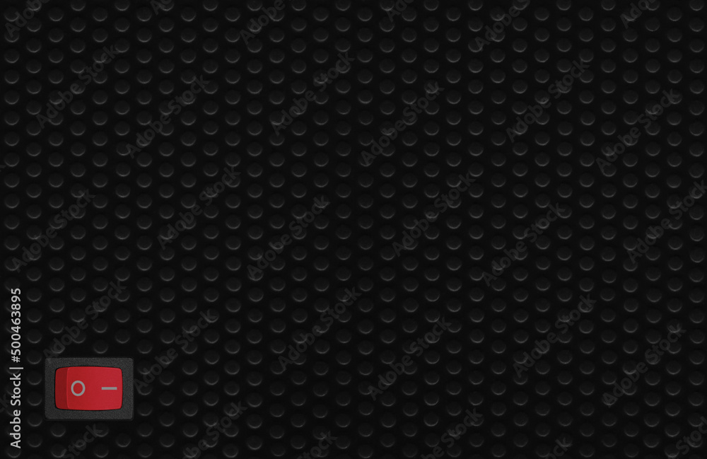 Red rectangle rocker power switch in on position, black abstract dot ...