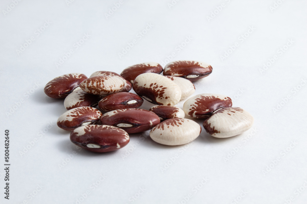 Small portion of raw fava beans in white, brown and red colors ...