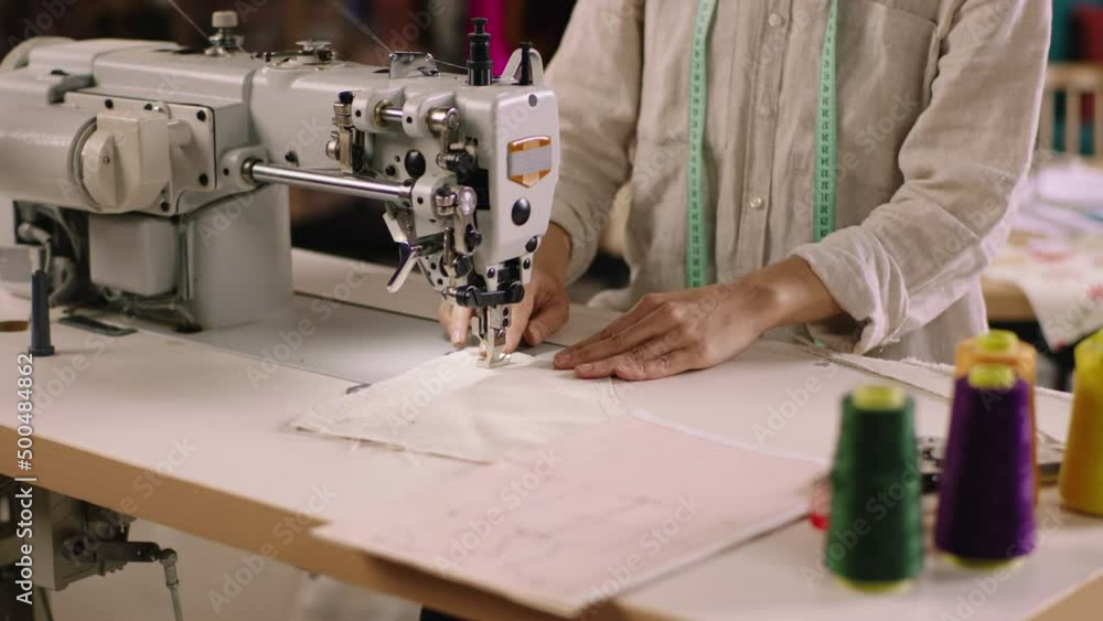 In front of the camera good looking dressmaker using her professional ...