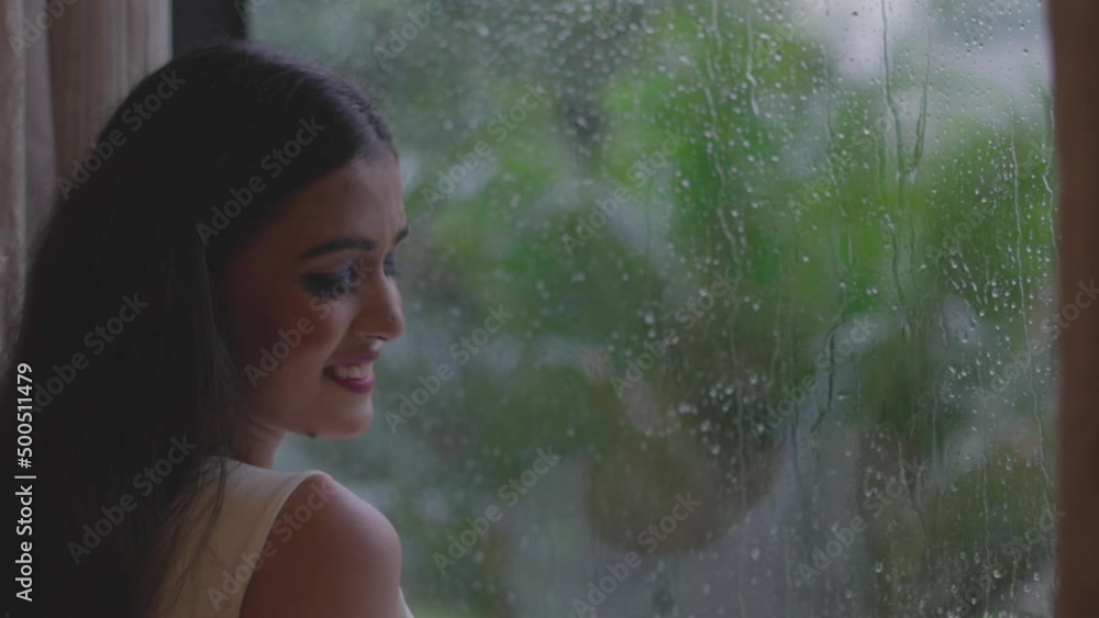 Vidéo Stock Young happy girl enjoying the rainy season seeing from ...