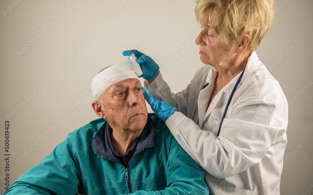 fractures in the limbs. doctor who checks, treats, wraps a patient to ...