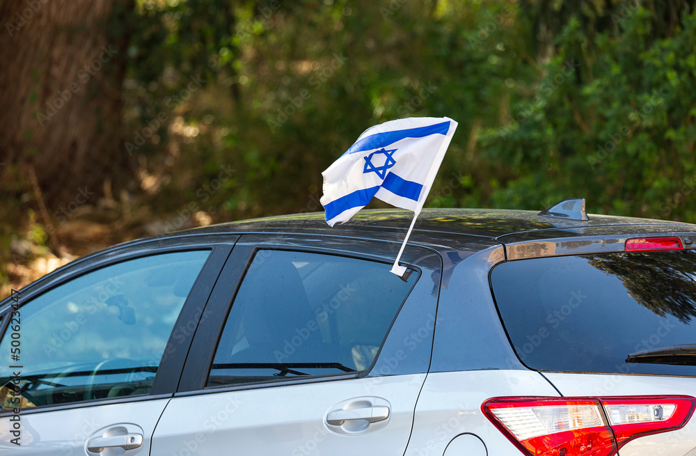 Israeli white-blue flag on on car roof flapping. Israel independence ...