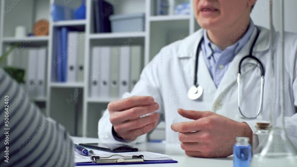 Reception at doctor. Therapist tells patient about treatment plan ...