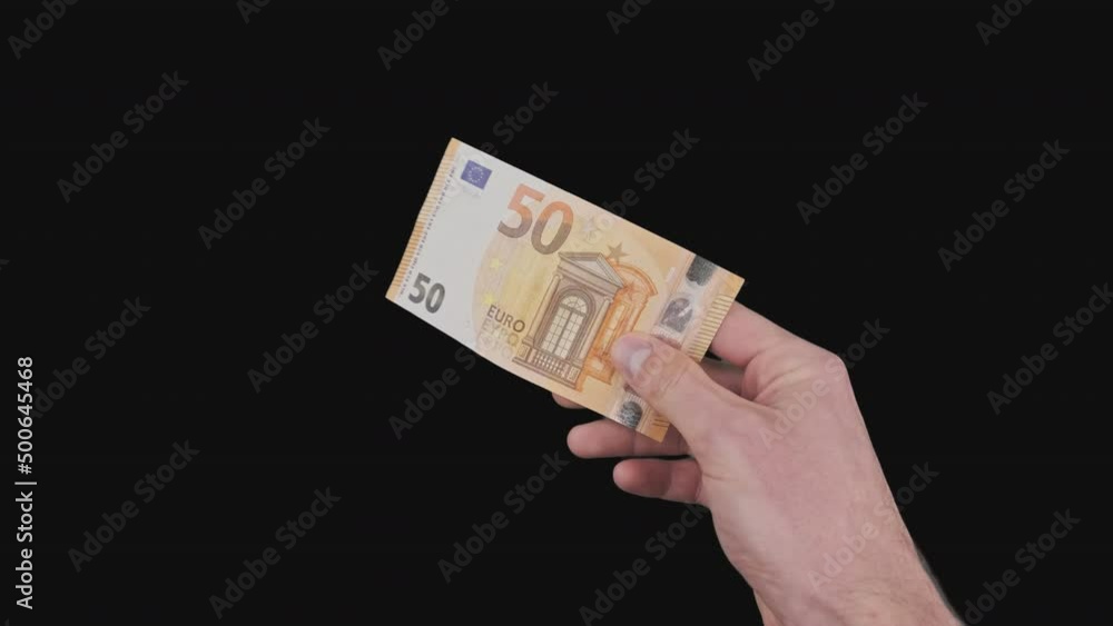 Male hand shows a banknote of 50 euros with alpha channel. Man holding ...