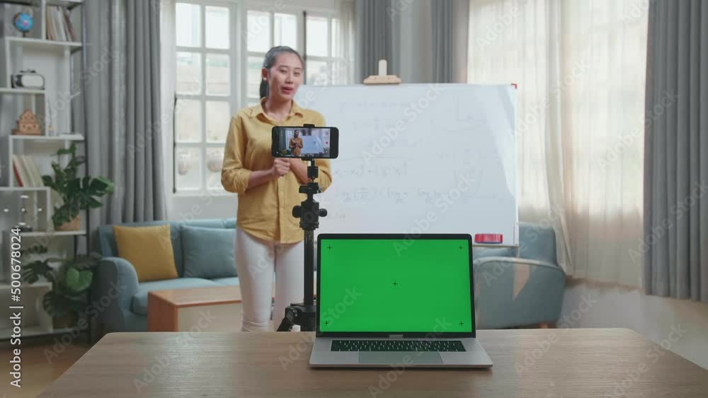 Asian Female Teacher With Green Screen Laptop Shoots Video By ...