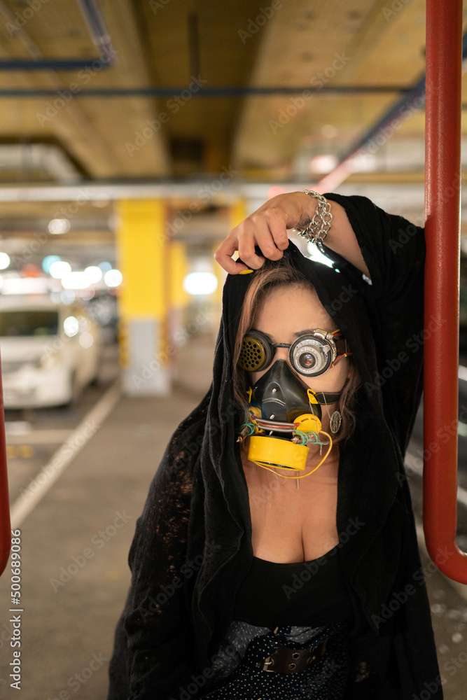 Sexy cyborg witch in cyberpunk goggles and a custom respirator, hooded ...