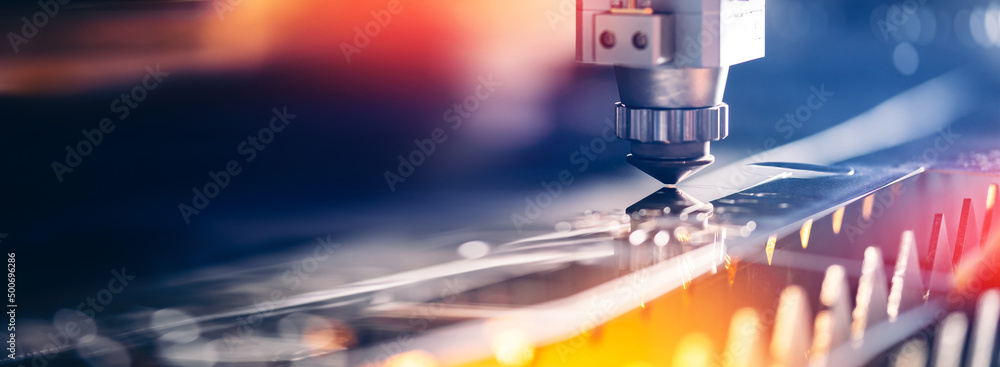 Blue color Laser CNC cut of metal with light spark, technology modern ...