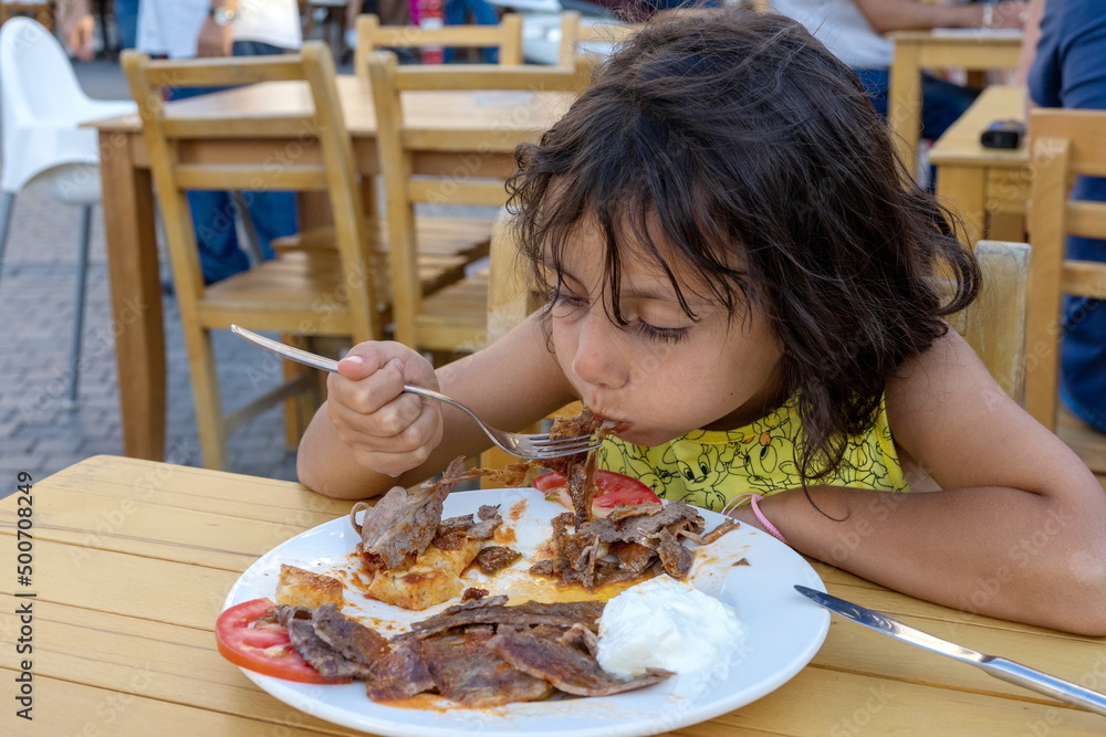 beautiful cute girl eating doner kebab. Stock Photo | Adobe Stock