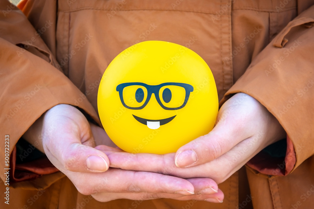 Hold a happy smiley in your hands. Good emotion on the face Stock Photo ...