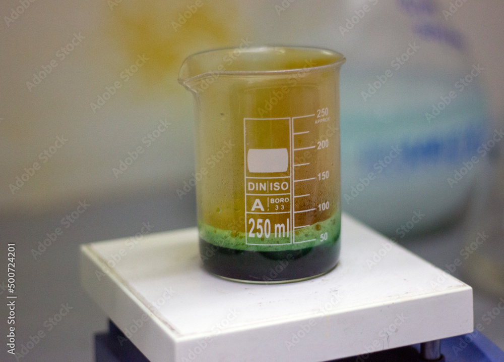 Yellowish fumes emery from the reaction occurring in the beaker. The ...