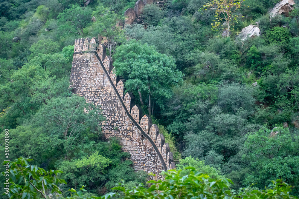 Great stone wall of an old ancient fort inside the dense forest of ...