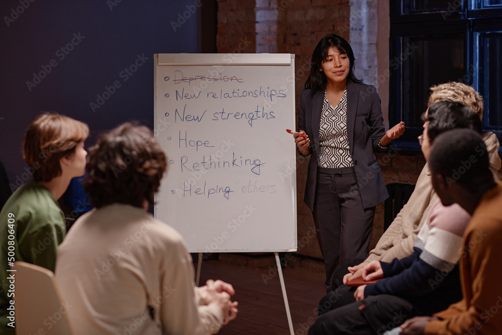 Horizontal shot of professional psychologist standing in front of ...