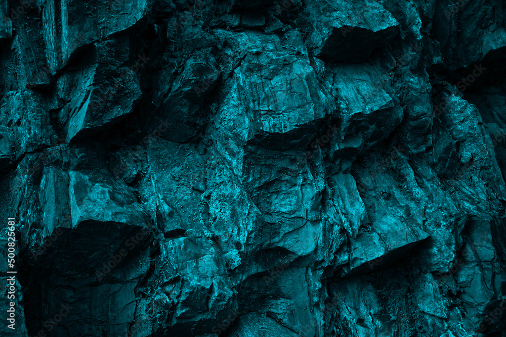 Blue green rock texture. Toned the rough surface of the mountain. Close ...