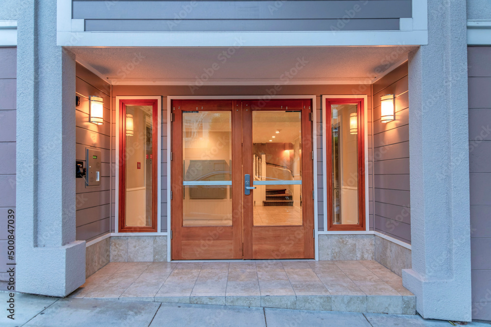 Double door with glass and wood frames of a modern apartment building ...