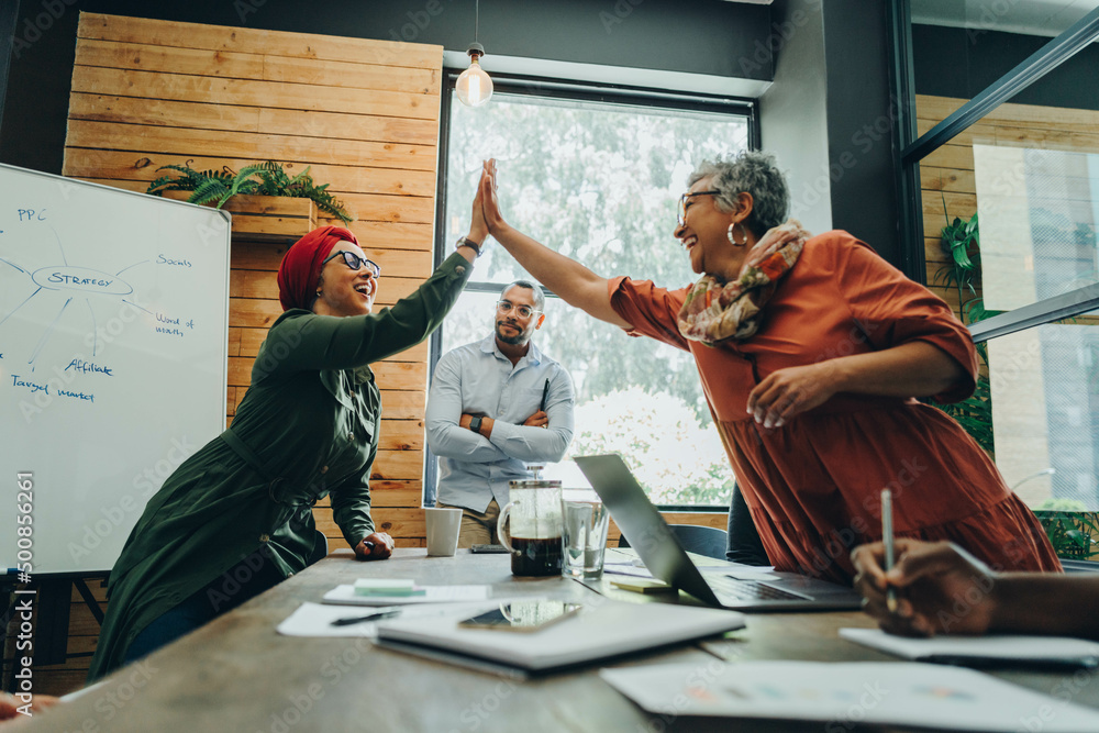 Happy businesswomen celebrating their success in an office Stock Photo ...