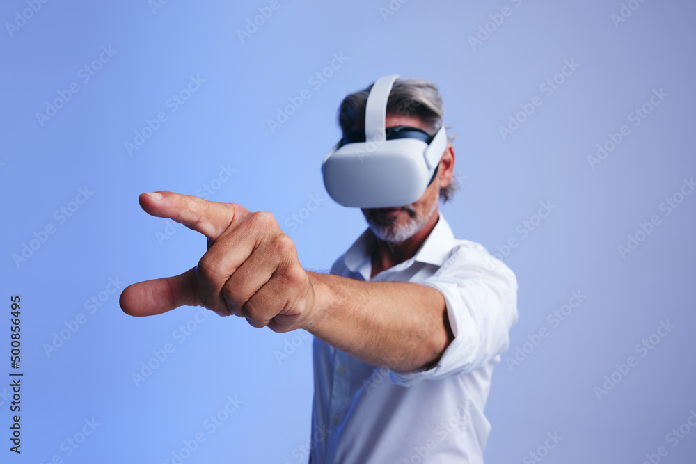 Mature businessman interacting with the metaverse Stock Photo | Adobe Stock