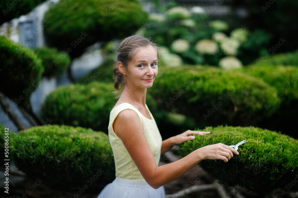 Beautiful Woman Girl In A Dress With Garden Scissors Cuts Juniper Horticultural And Topiary
