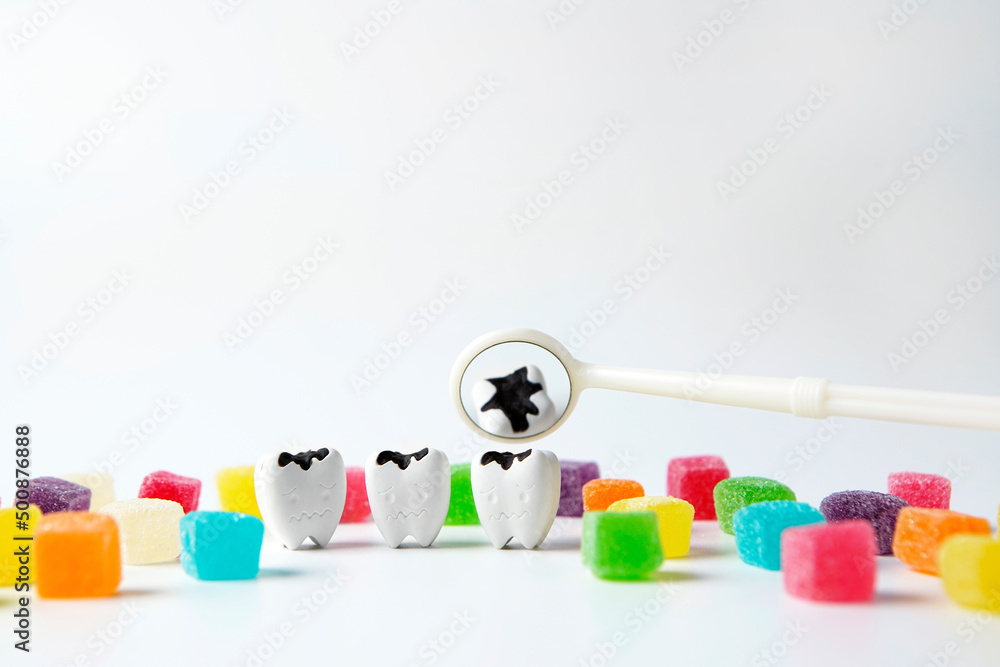 Decay tooth with sweet sugar candy and mirror mouth reflect black ...