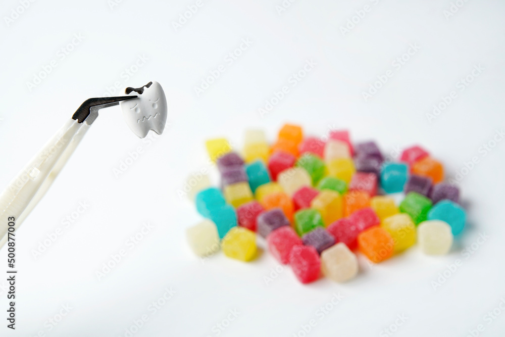 Cavity and tooth decay pinching by clamp With sugar jelly candy, Should ...