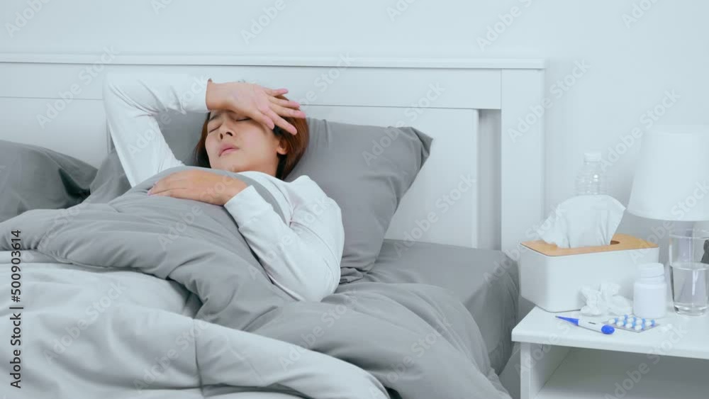 Asian woman flu and cold, feeling sick and sleeping on bed at home ...