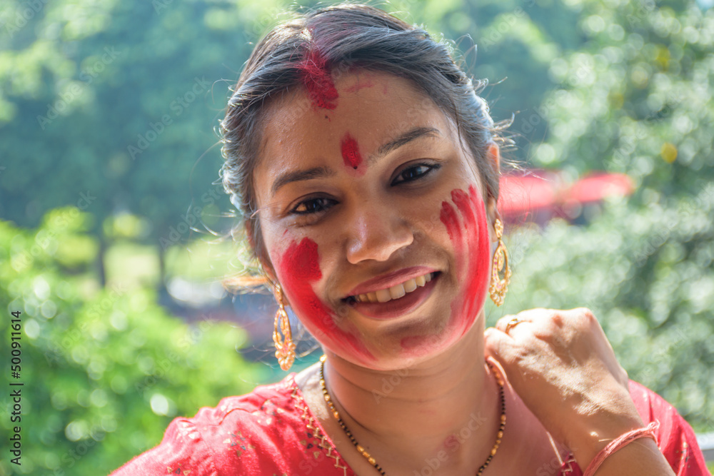 Happy young Bengali woman celebrates Sindur Khela tradition in Durga ...