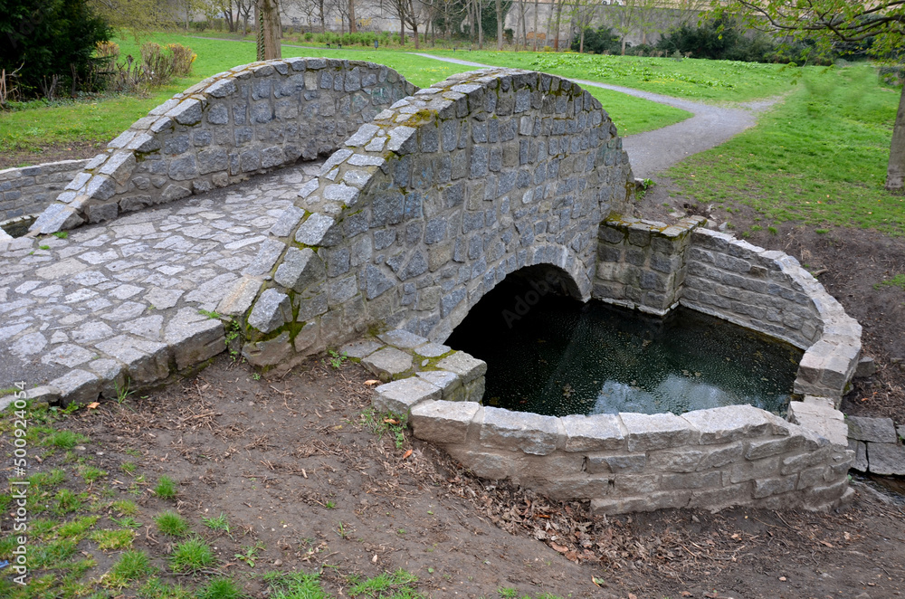 arch bridge, stone granite with railings to the arch. english landscape ...