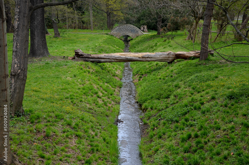 arch bridge, stone granite with railings to the arch. english landscape ...