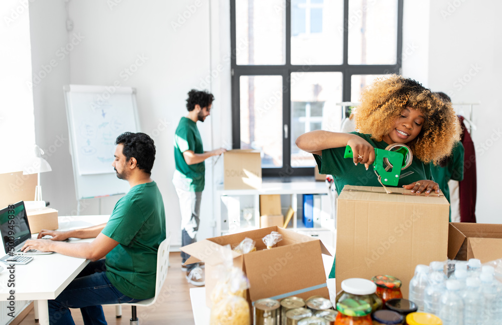 charity, donation and volunteering concept - happy smiling woman with ...