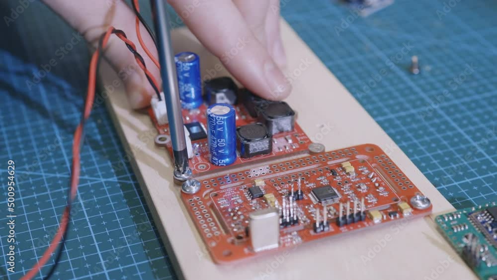 Male hands replace smd elements by soldering. Repair of electronic ...