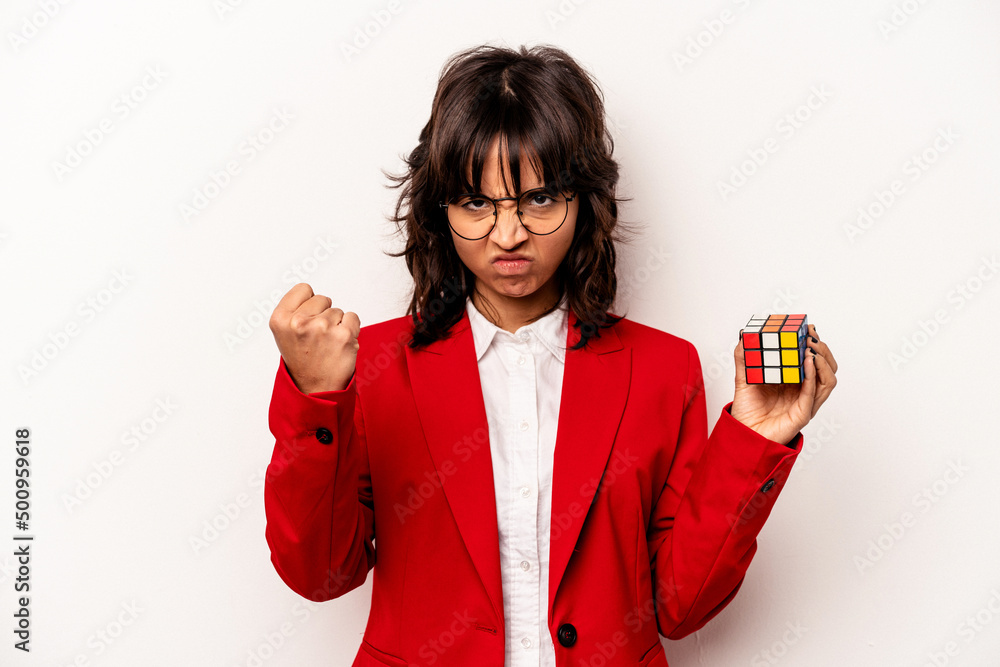Young business woman holding a Rubik’s cube isolated on white ...