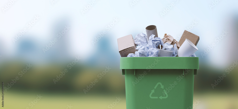 Garbage can full of paper waste Stock Photo | Adobe Stock