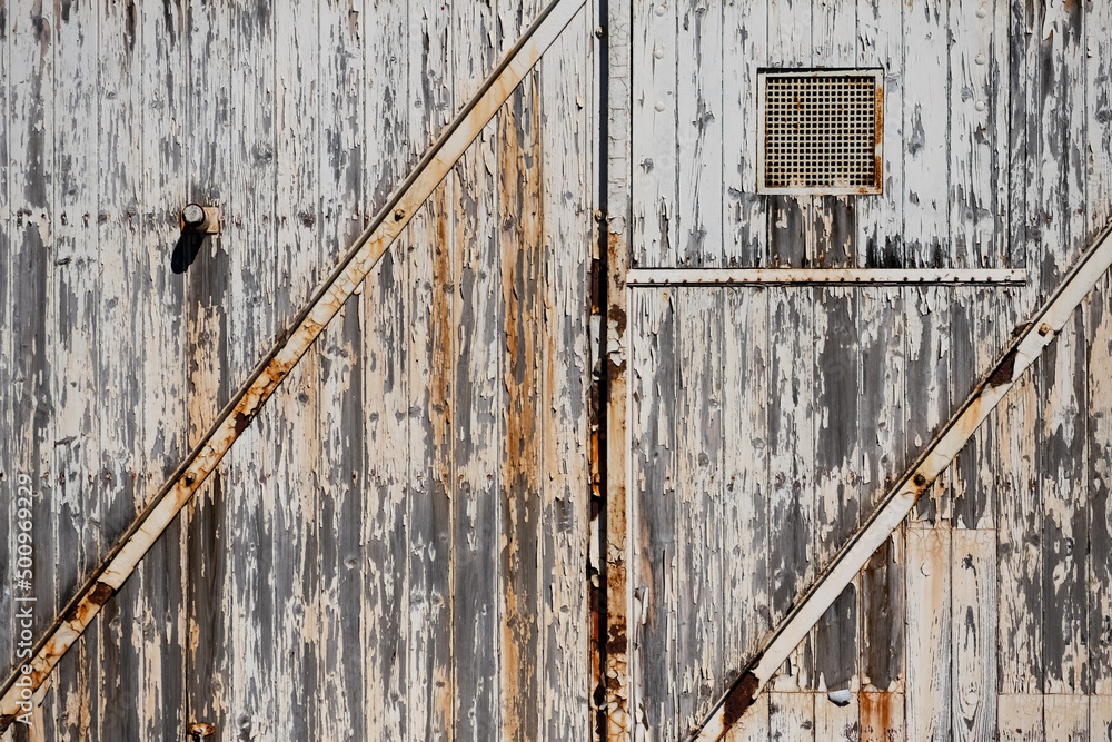 Peeled off paint on a shabby wooden old vehicle surface of a ruined ...
