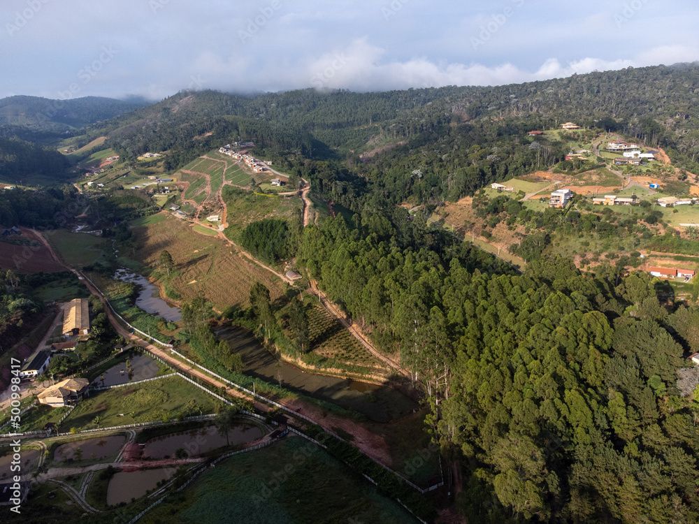 Small country town with food production on plantations, small houses ...