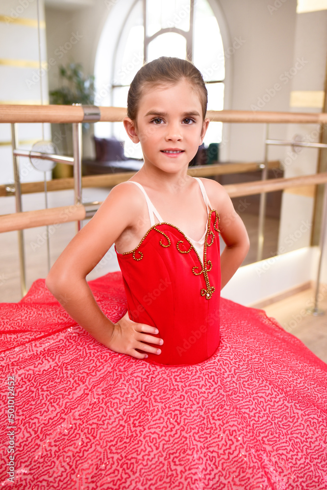 Full length portrait of a cute little ballerina in a performance dress ...