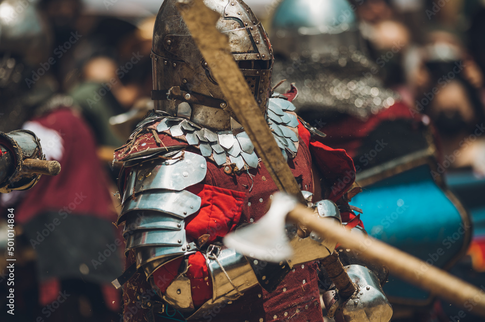 Poster Pitch battle of medieval knights, using metal armor, axes ...
