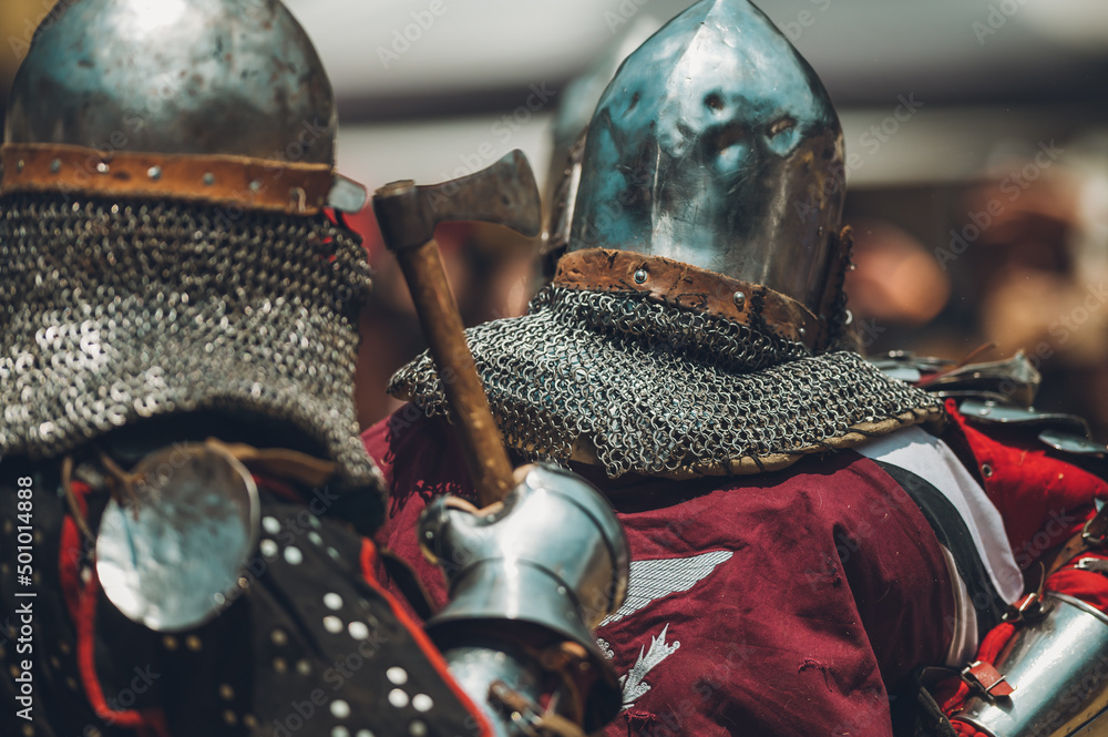 Pitch battle of medieval knights, using metal armor, axes, swords and ...