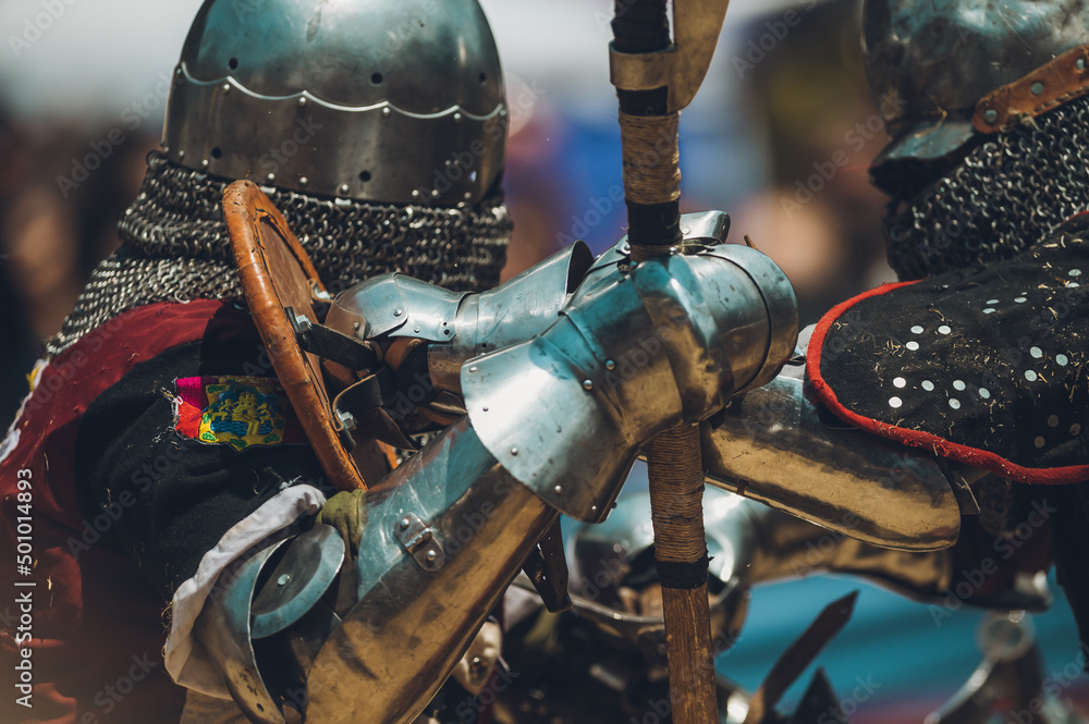 Naklejka Pitch battle of medieval knights, using metal armor, axes ...
