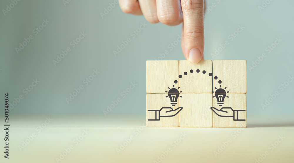 Knowledge and ideas sharing between two people ideas icon on wooden ...