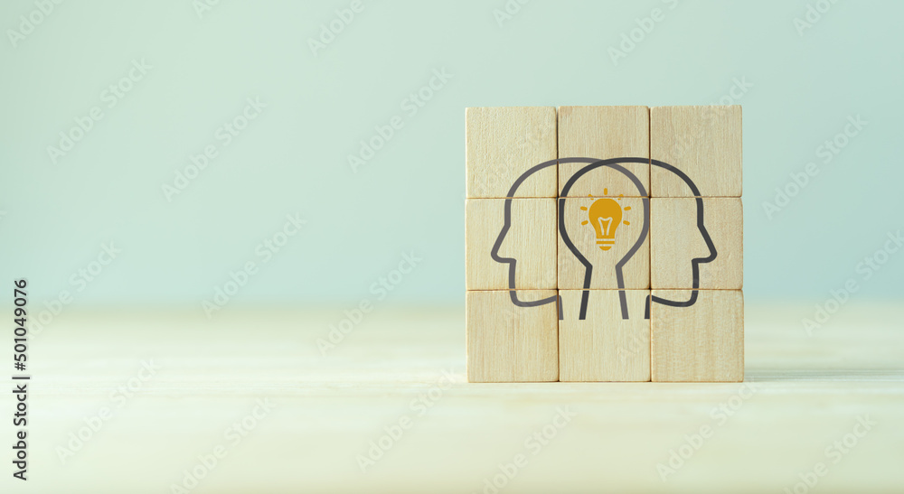 Knowledge and ideas sharing between two people head icon on wooden cube ...