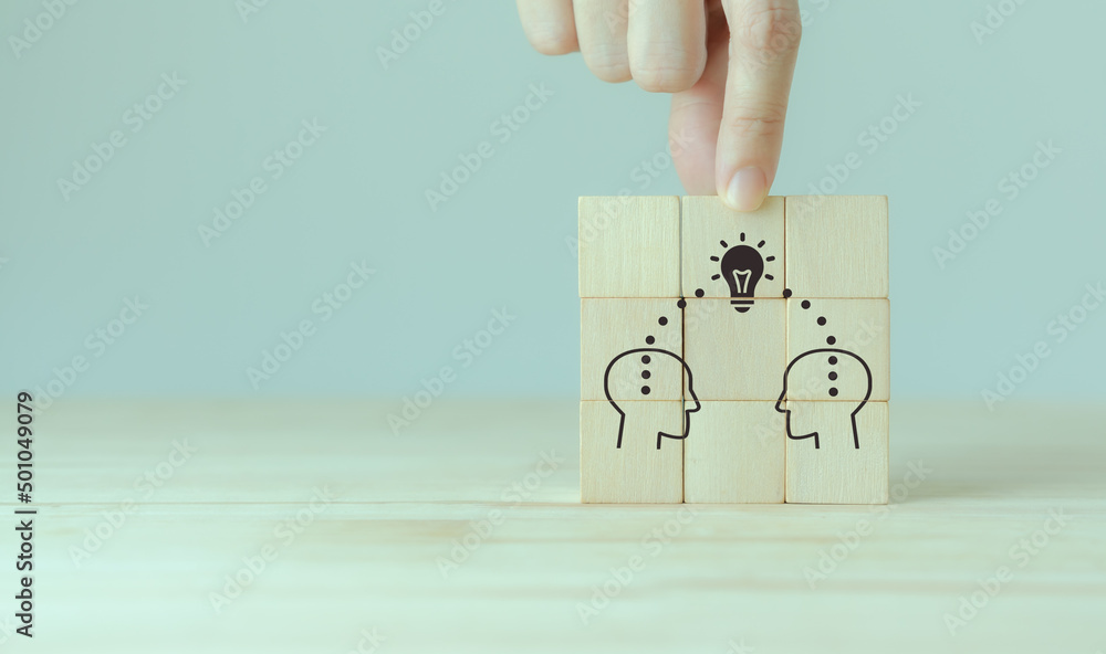Knowledge and ideas sharing between two people head icon on wooden cube ...