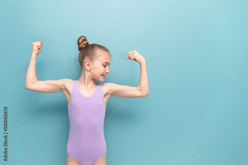 A young gymnast girl, stretching her muscles, imagine that she has a ...